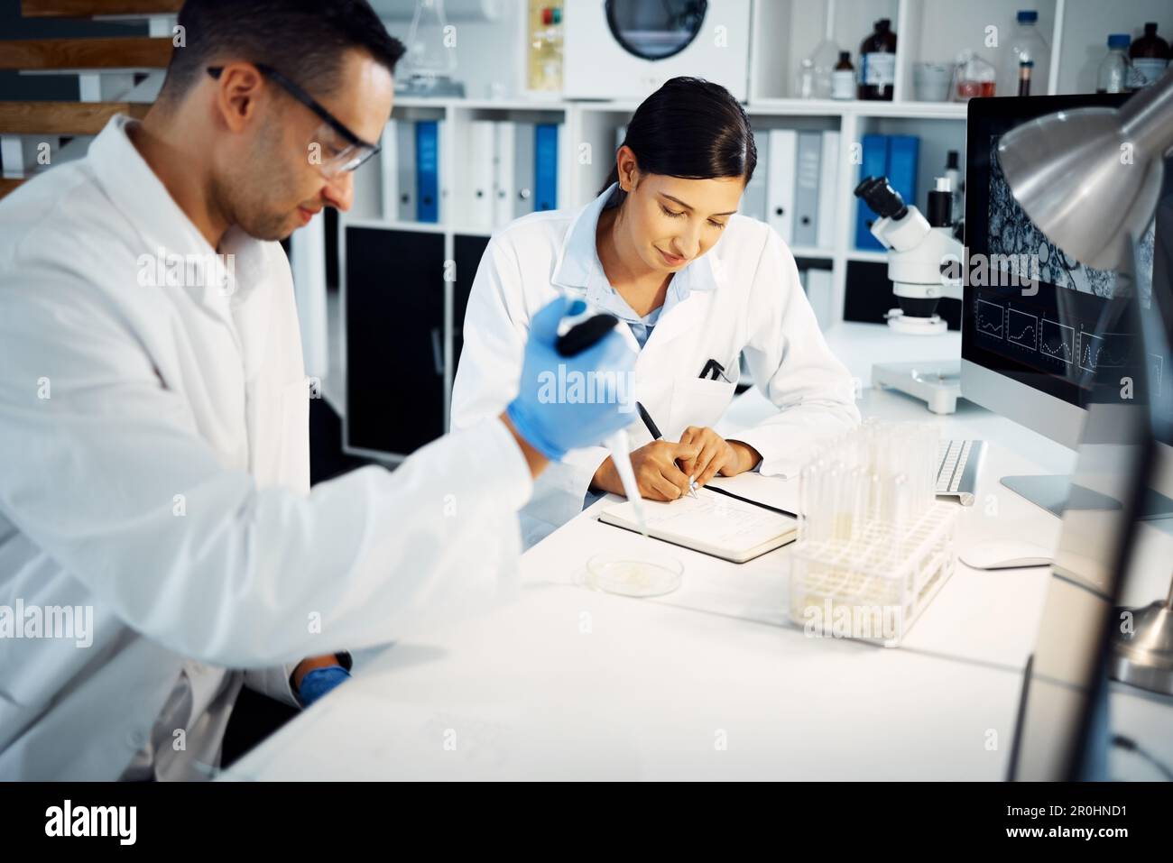 Theres a lot going on in this lab. two young scientists conducting ...