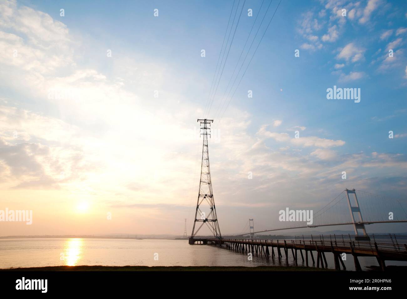 Electricity pylons over a bridge in sunset, Wales, Great Britain Stock ...