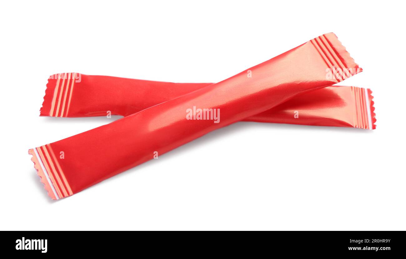 Red sticks of sugar on white background Stock Photo - Alamy