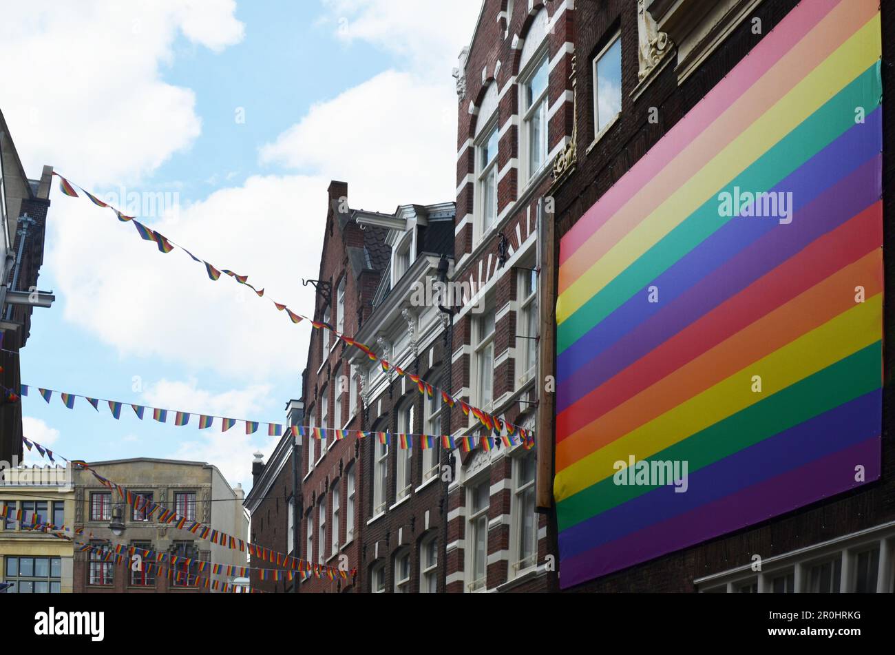 Picturesque view of city street with rainbow flags Stock Photo - Alamy