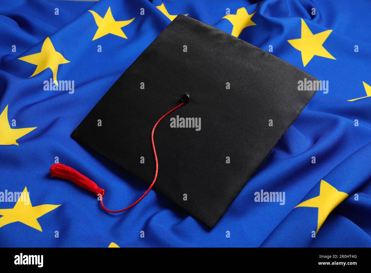 Black graduation cap on flag of European Union Stock Photo - Alamy