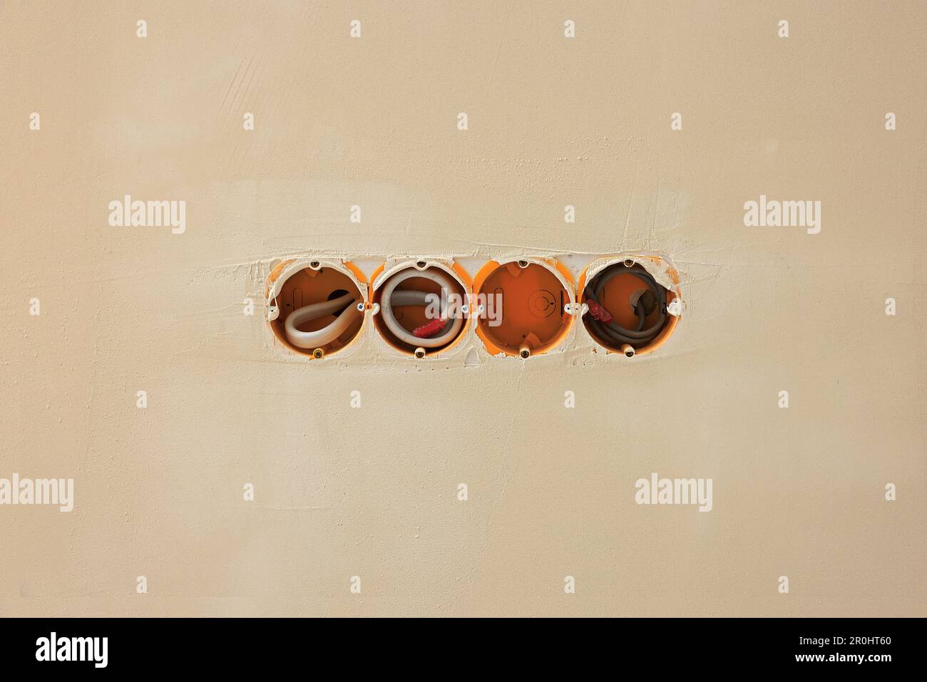 Holes for socket in white clean wall Stock Photo - Alamy
