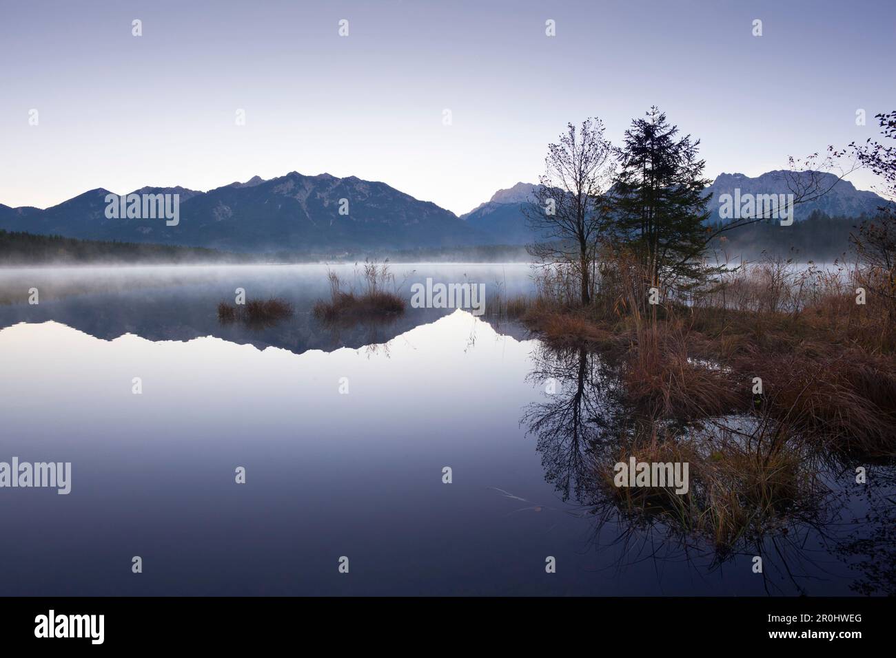 Morning mist, view over lake Barmsee to the Soiern mountains and ...