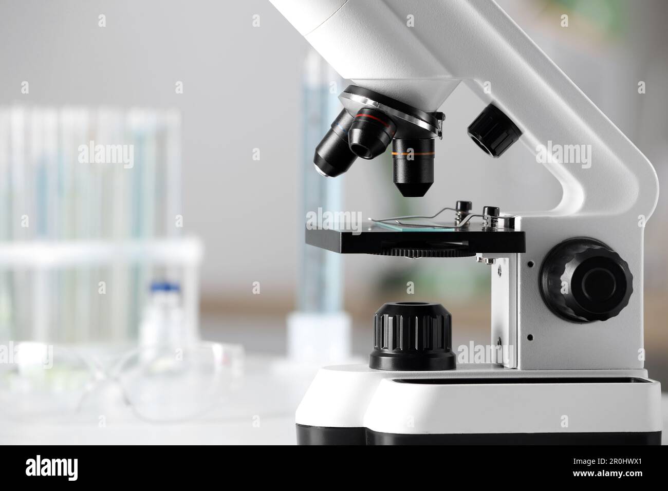Modern medical microscope on white table in laboratory, closeup. Space ...