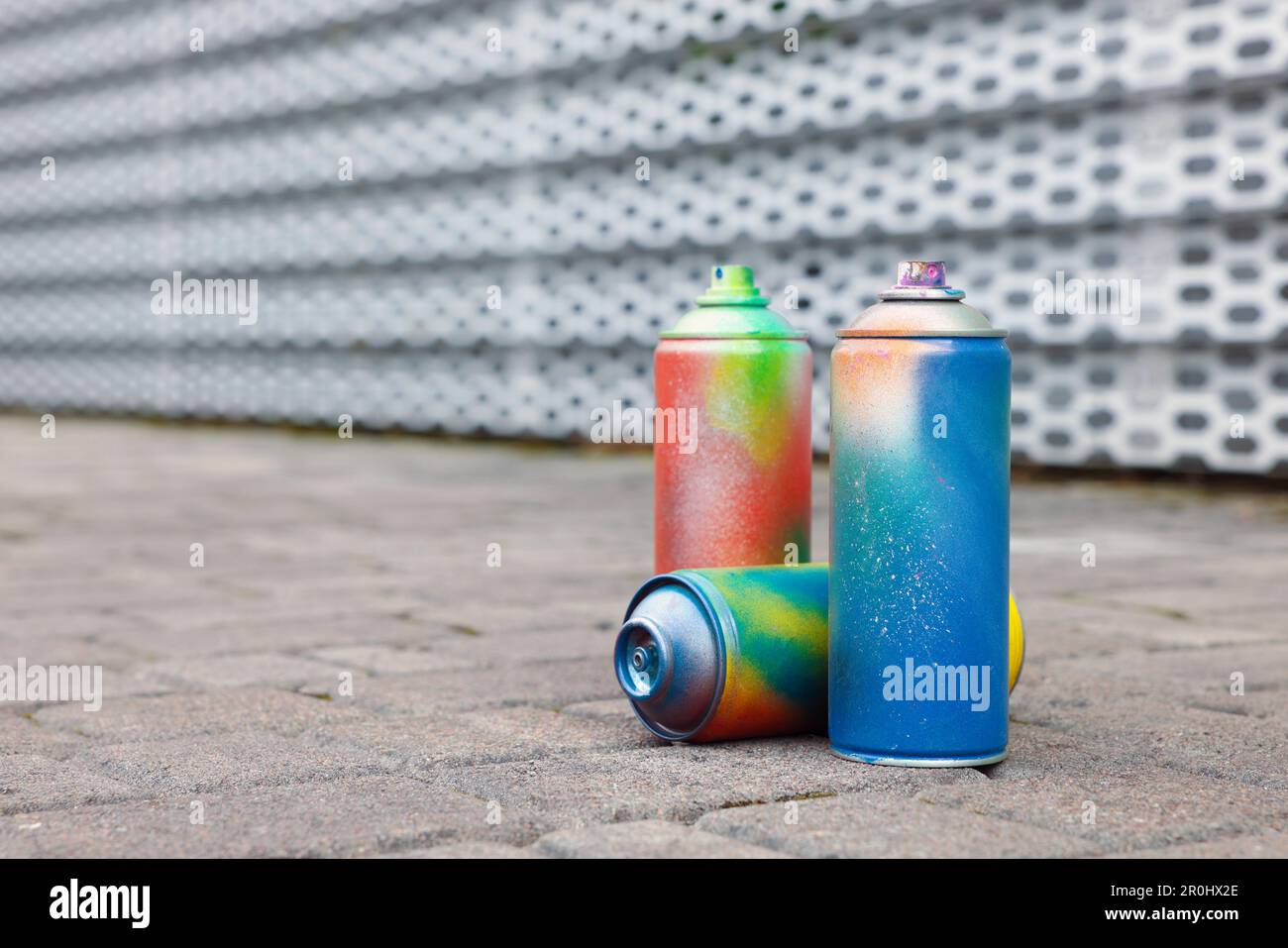 Used cans of spray paints on pavement, space for text Stock Photo - Alamy