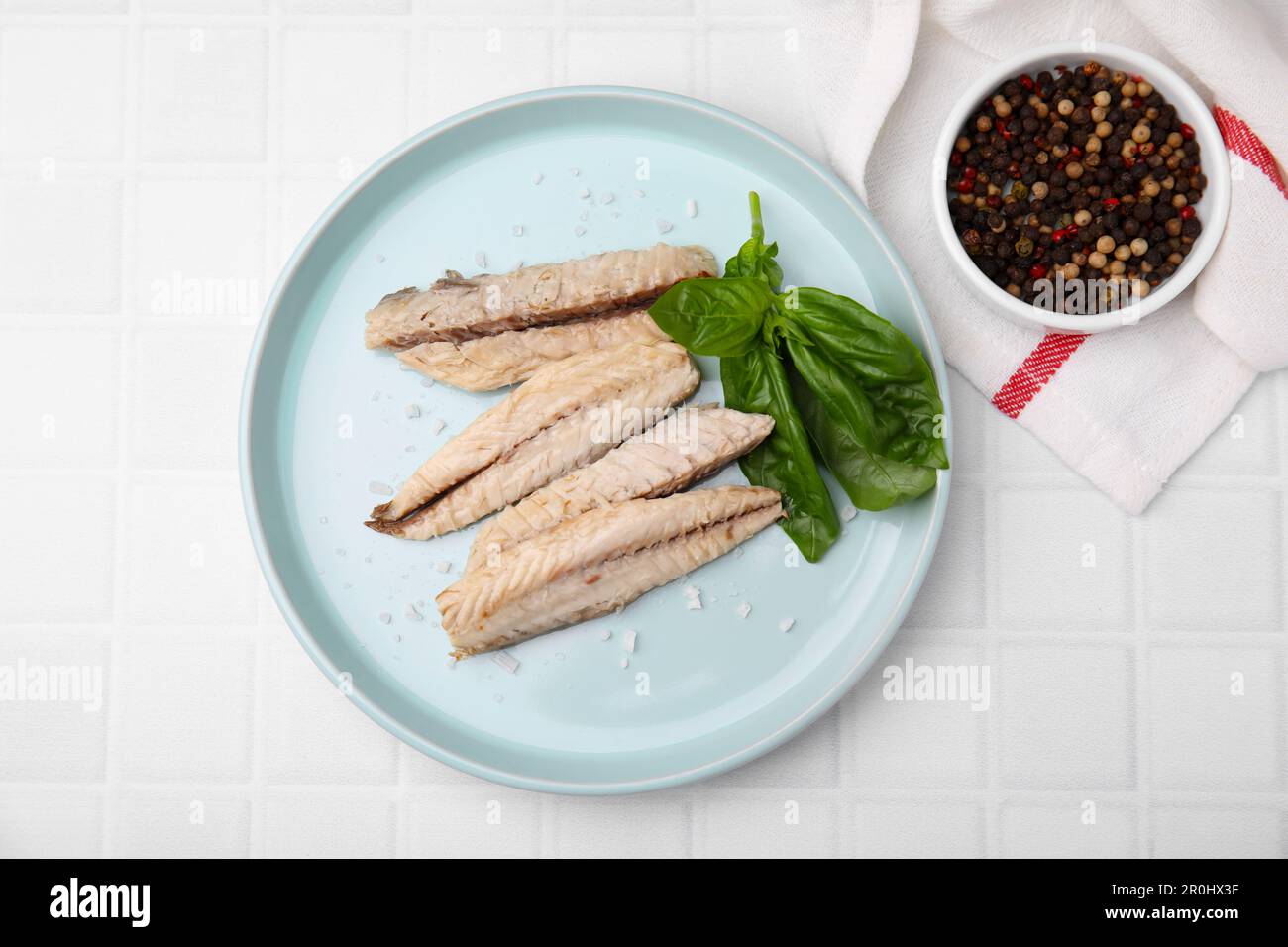 Canned mackerel fillets served on white tiled table, flat lay Stock ...