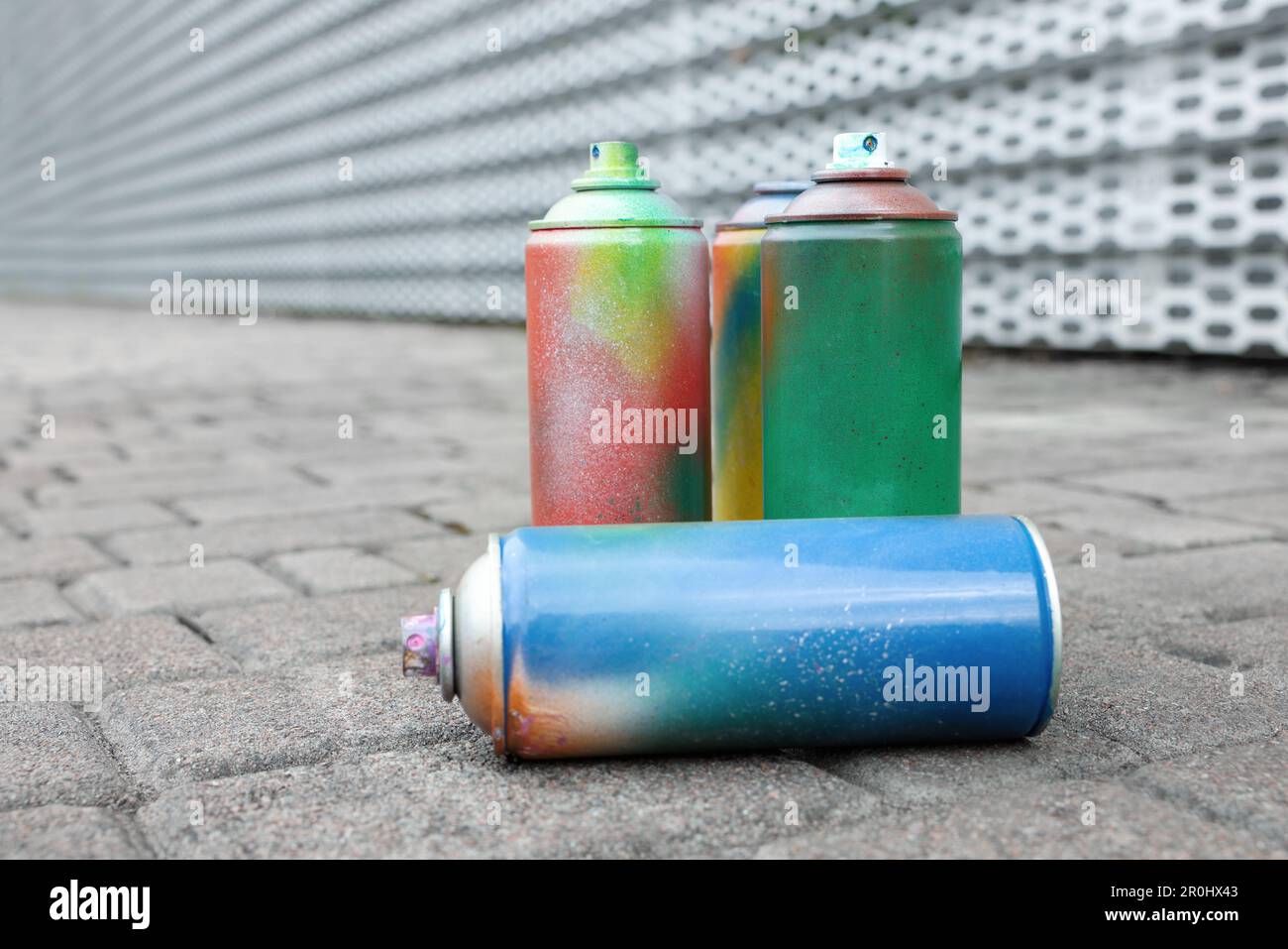 Used cans of spray paints on pavement, closeup Stock Photo - Alamy