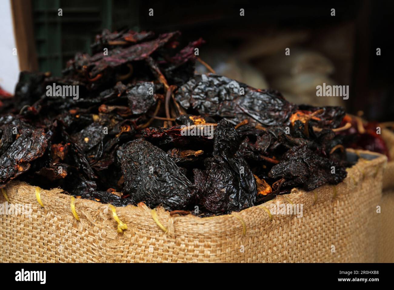 Pile of dried black ancho chiles in burlap, closeup Stock Photo - Alamy