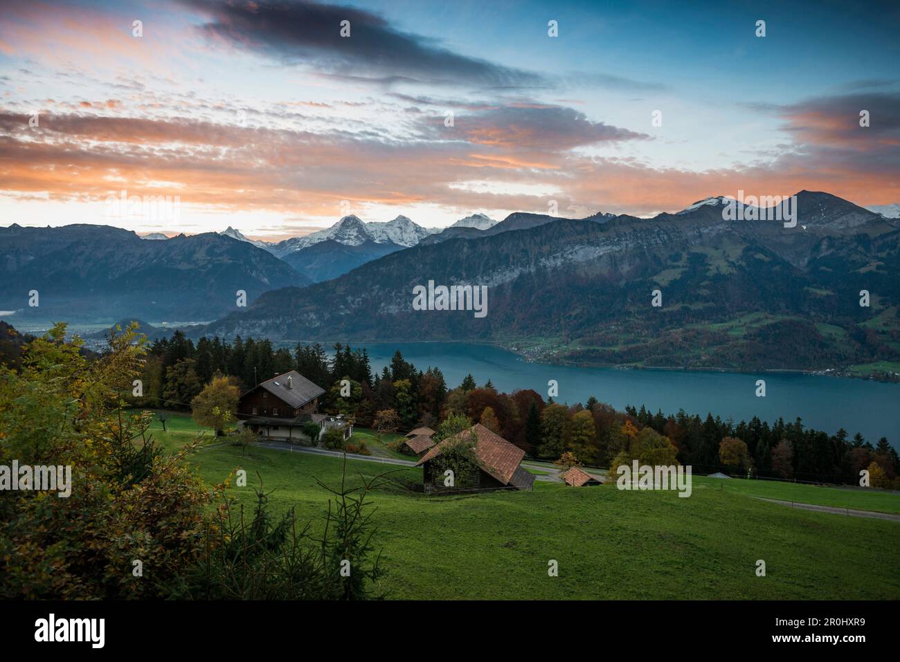 View over Lake Thun to sunrise above Eiger, Moench and Jungfrau ...