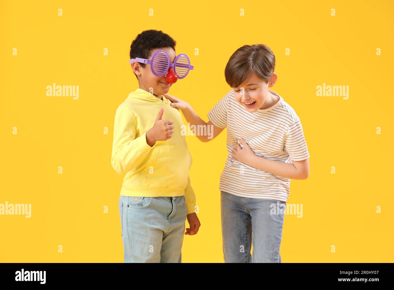 Little boys with funny disguise on yellow background. Children's Day ...