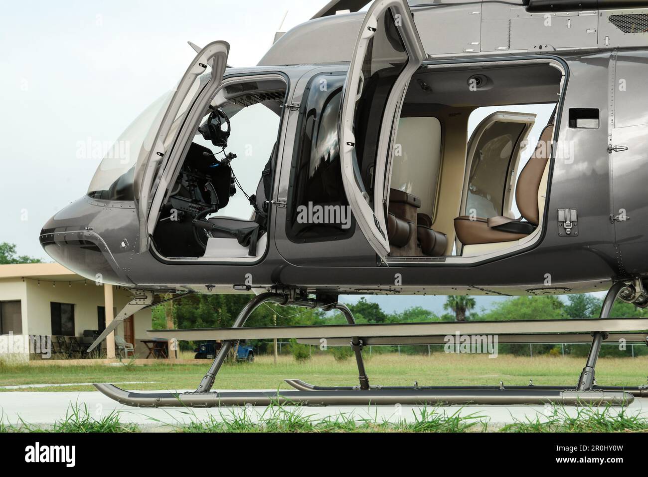 New helicopter with open cabin doors on helipad outdoors Stock Photo ...