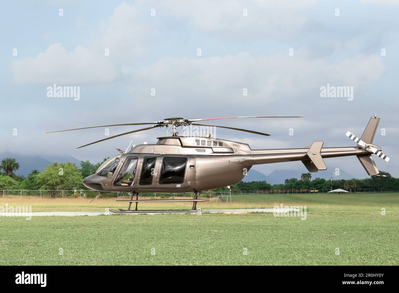 Beautiful modern helicopter on helipad in field Stock Photo - Alamy