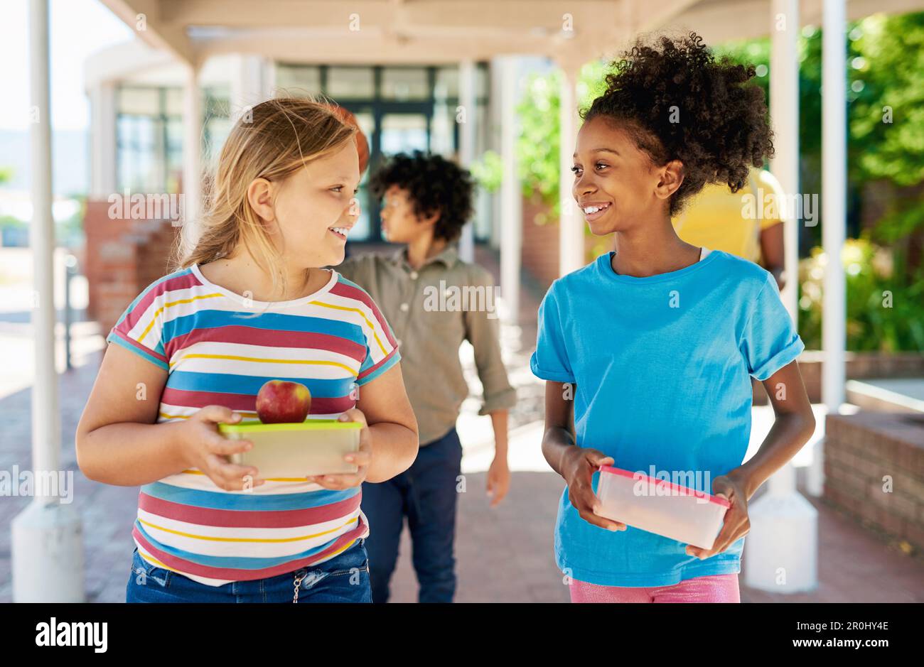 This is our time to catch up. two young girls walking together at ...