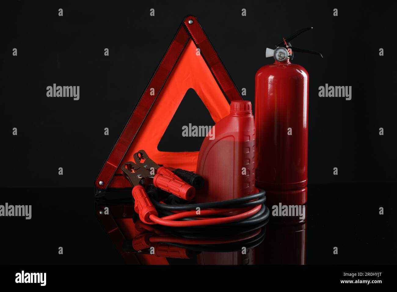 Emergency warning triangle, red fire extinguisher, battery jumper ...