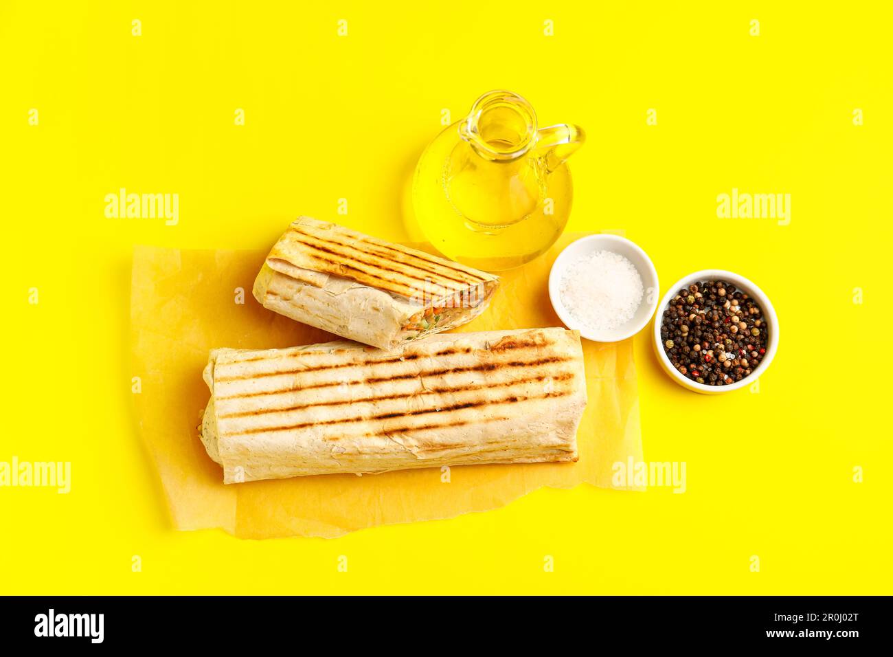 Baking paper with tasty shawarma on yellow background Stock Photo - Alamy