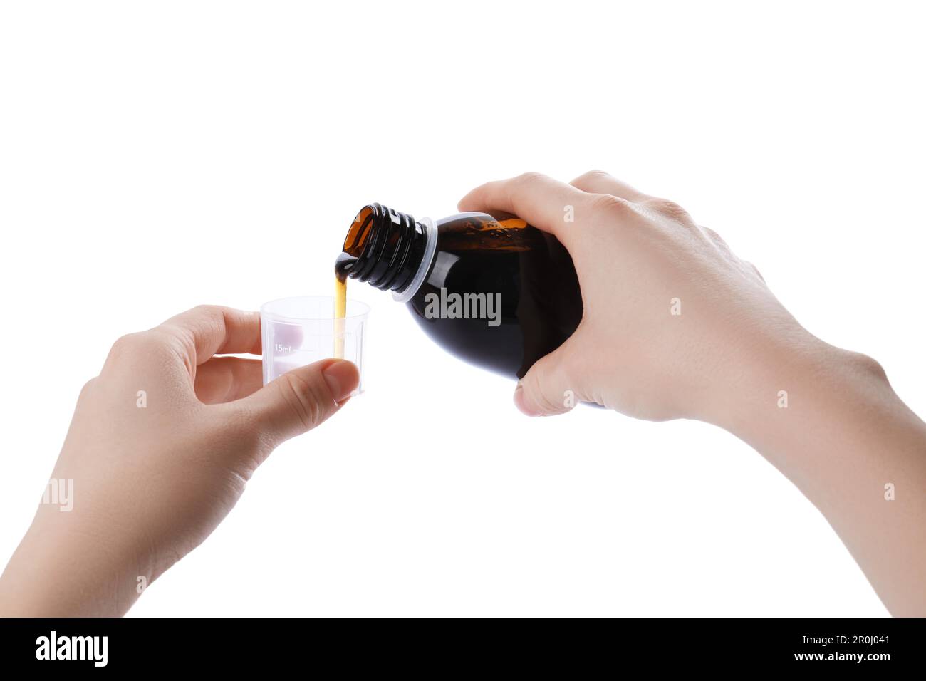 Woman pouring syrup into measuring cup from bottle isolated on white ...