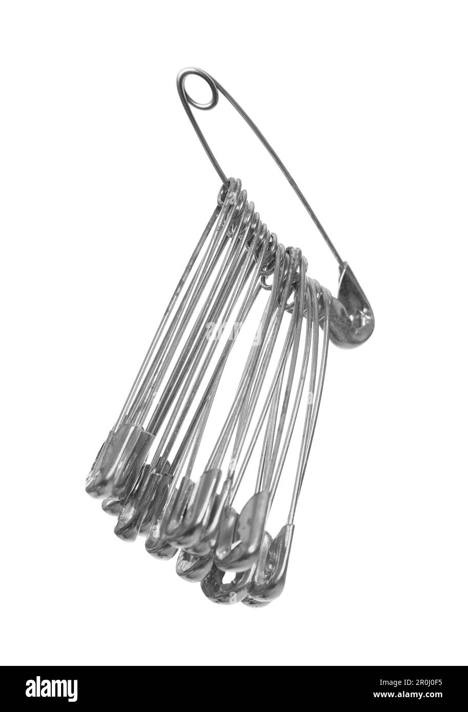 New metal safety pins on white background Stock Photo - Alamy