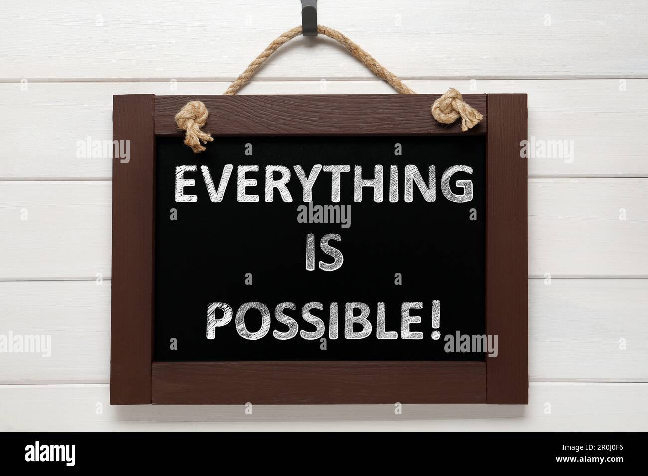 Small chalkboard with motivational quote Everything is possible hanging ...