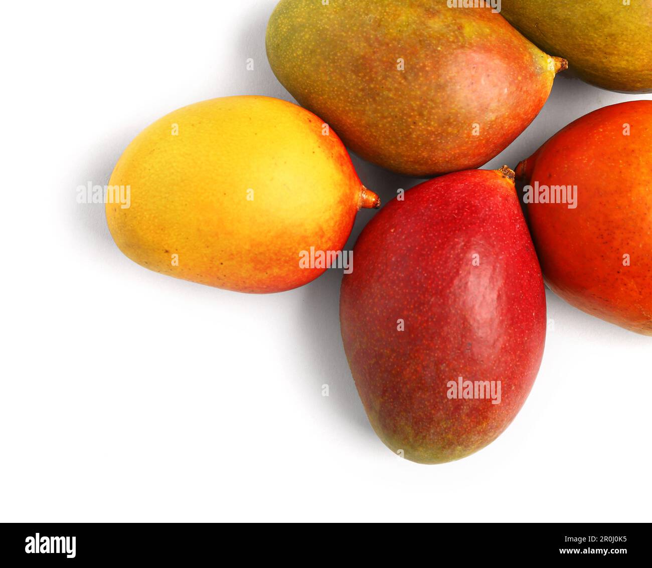 Fresh ripe mangoes on light background Stock Photo - Alamy