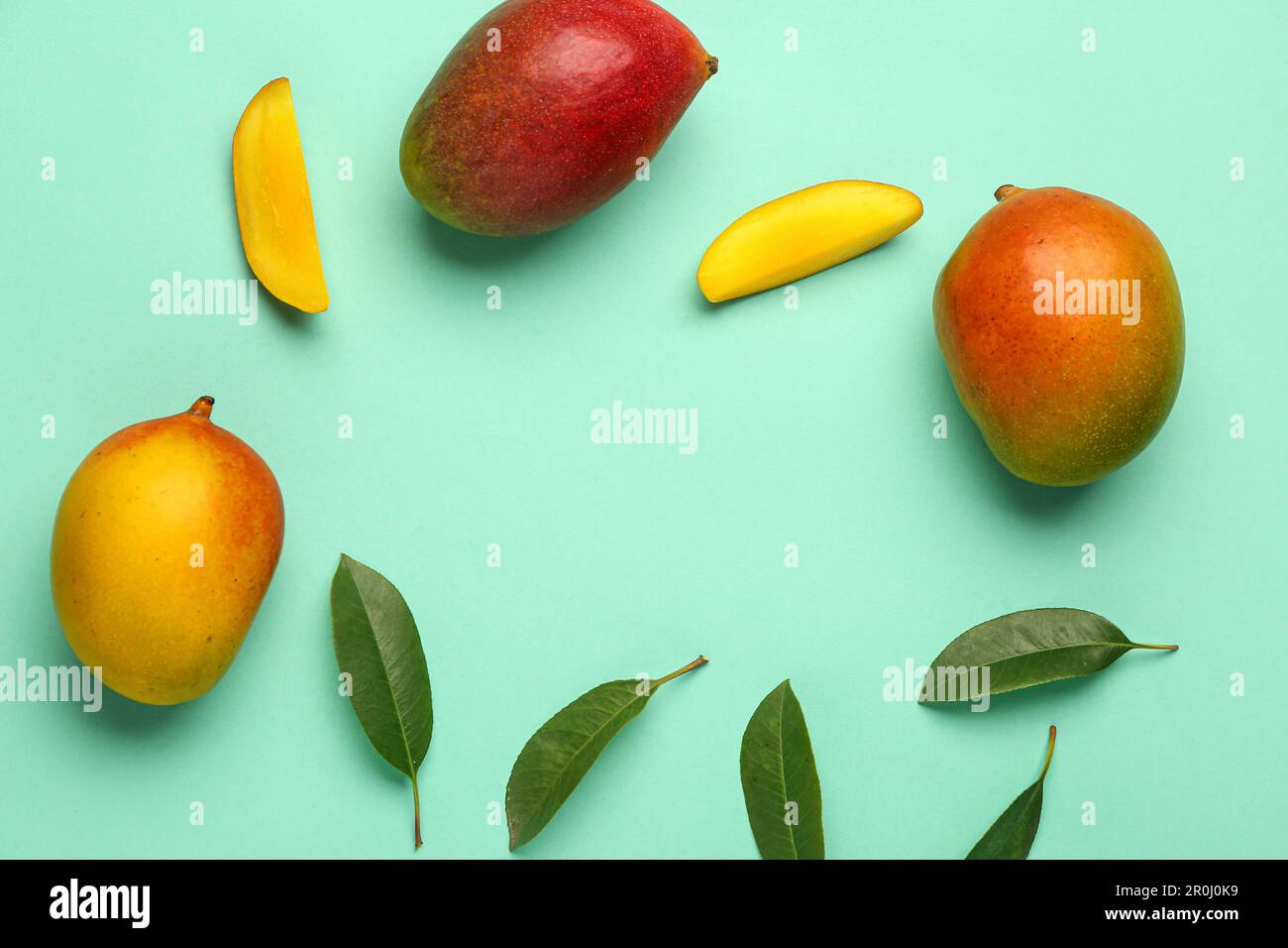 Frame made of fresh ripe mangoes on turquoise background Stock Photo ...
