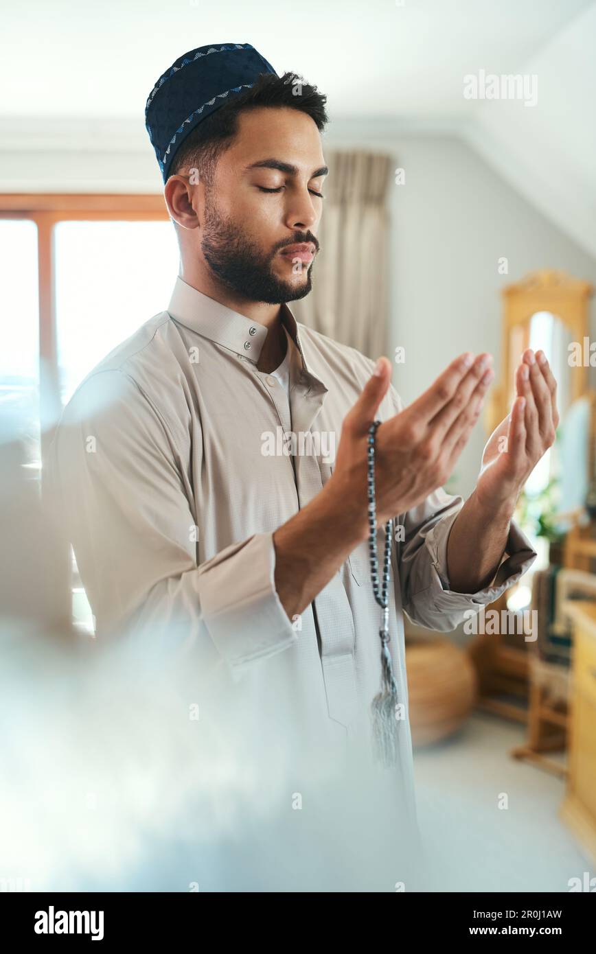 The most potent instrument of action. a young muslim man praying in the ...