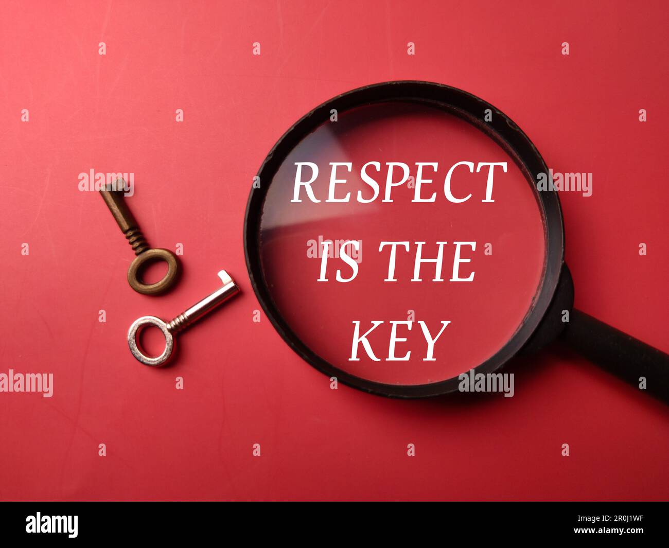 Magnifying glass and key with the word RESPECT IS THE KEY on a red ...