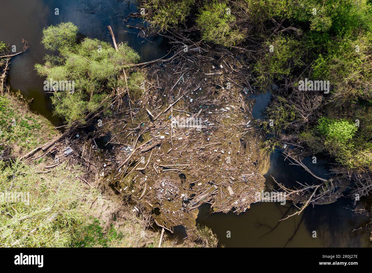 Floating pile of debris from branches and plastic accumulated in the ...