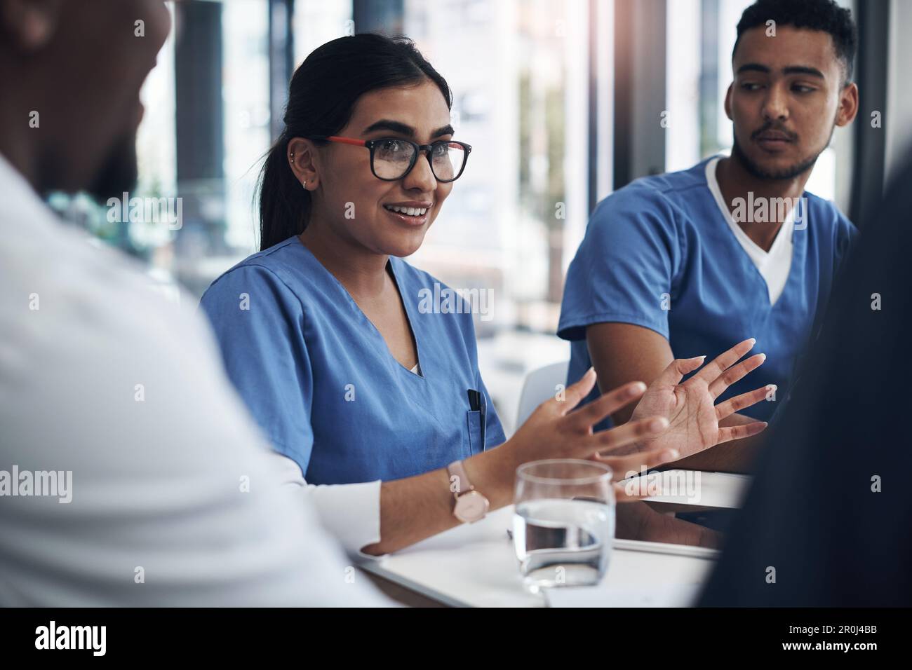 I have everyones rapt attention. a group of nurses and doctors having a ...