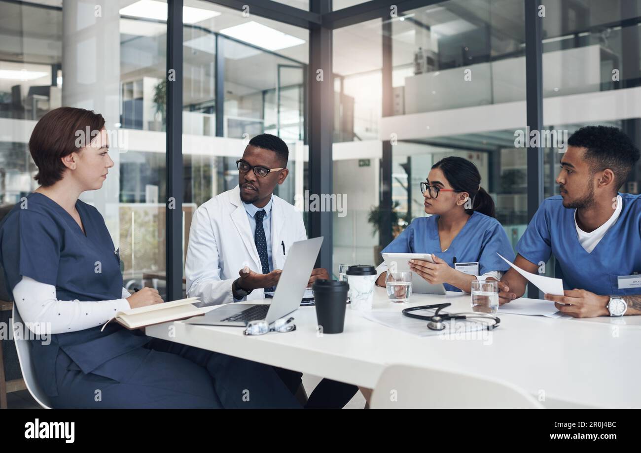 Doctors conference table nurses serious hi-res stock photography and ...