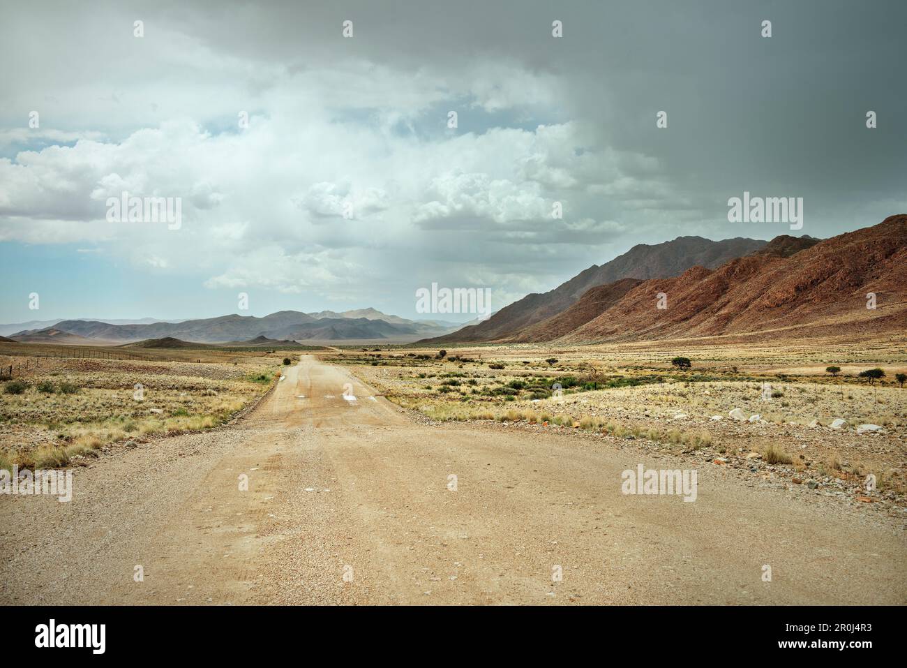 Dusty road after heavy rainfall with puddles, Tiras Mountain Range ...