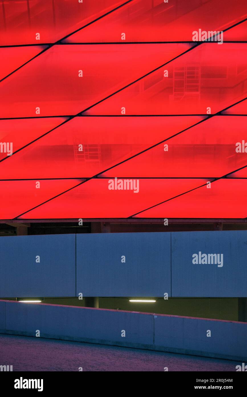 detail of facade of Allianz Arena at night, red light, football stadium ...