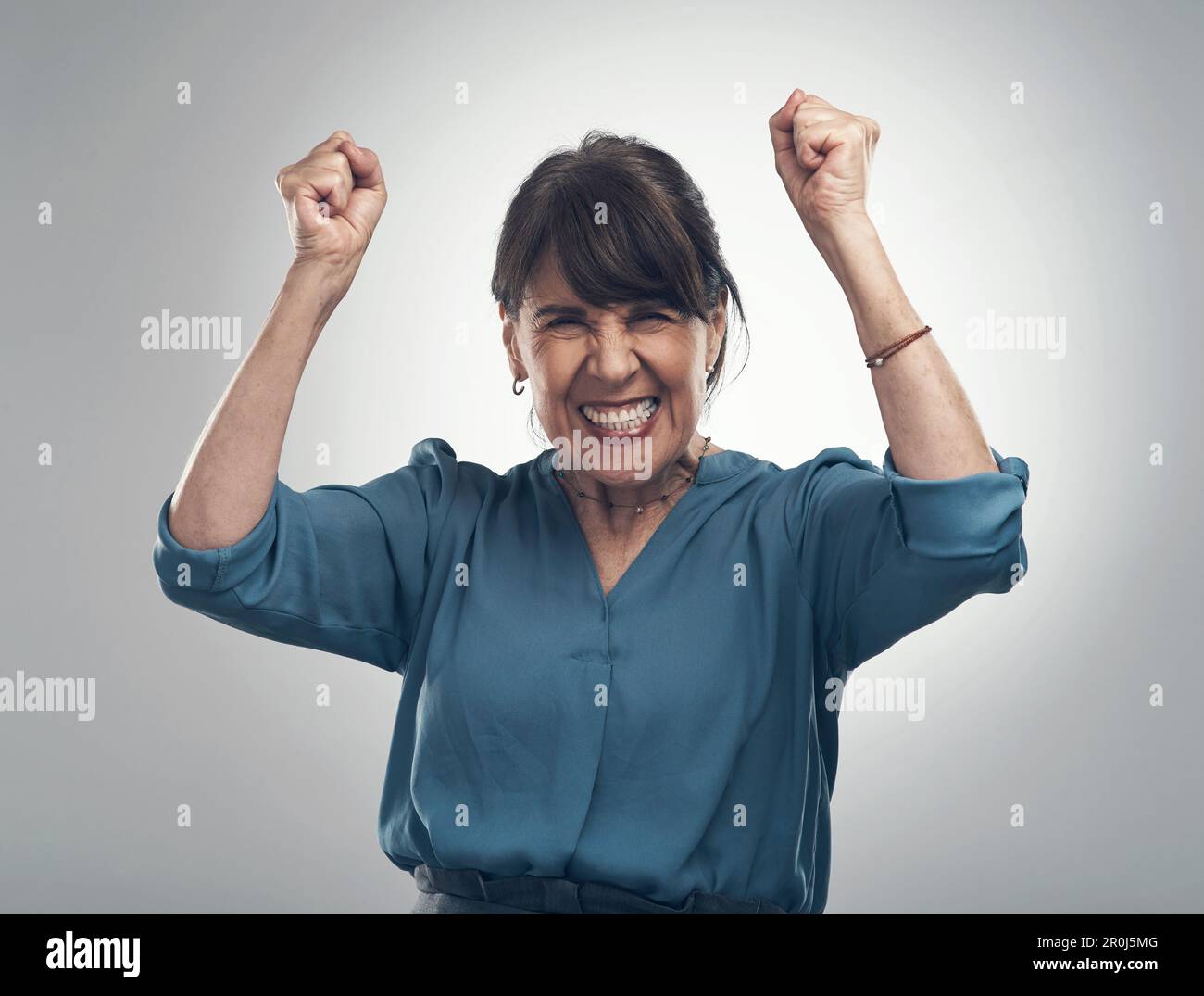 Heres my happy dance. Studio portrait of a senior woman cheering ...