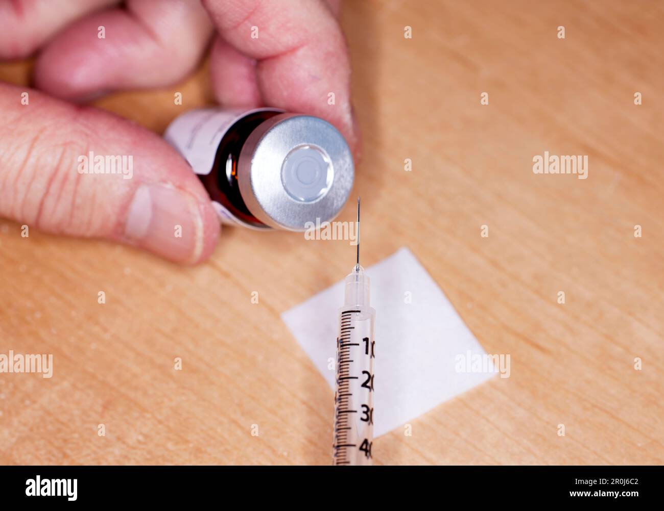 Close up of handheld needle and syringe with Testosterone Vial Stock ...