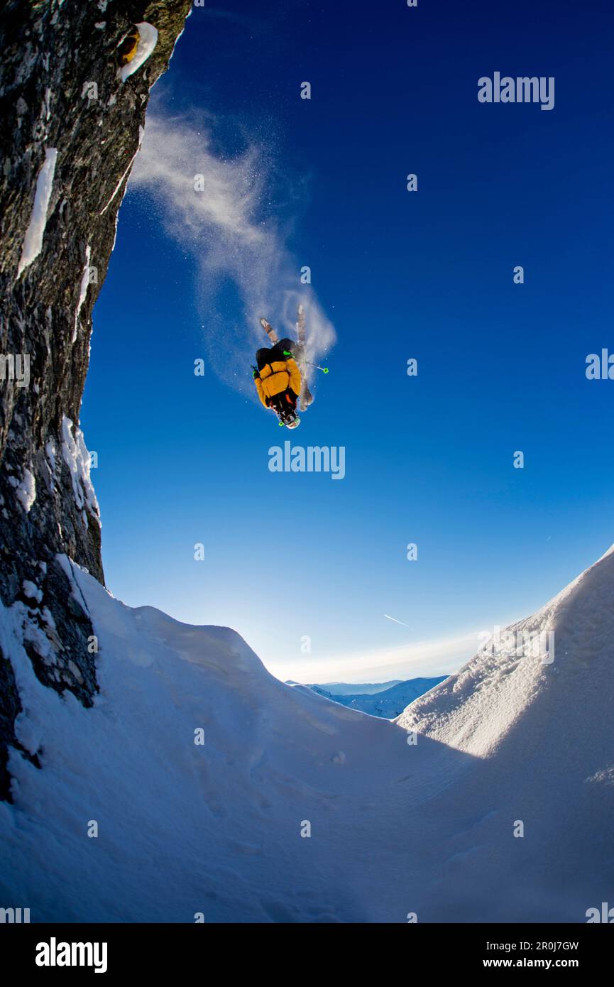 Skier doing a back flip over rocks, head down, Hochfuegen, Zillertal ...
