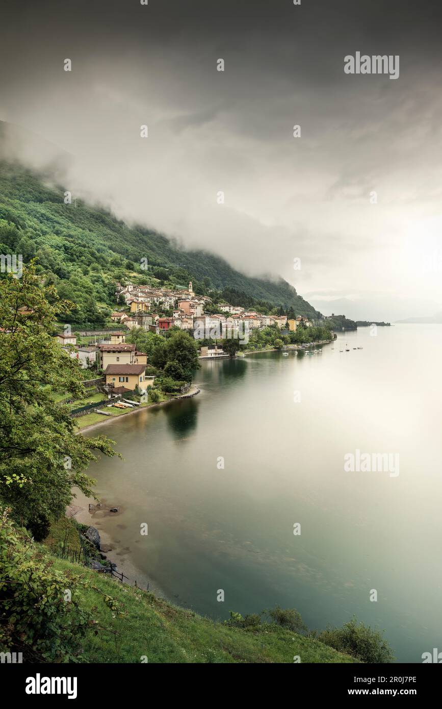 Steep coast with view to Dorio village during rain, Lake Como, Lombardy ...