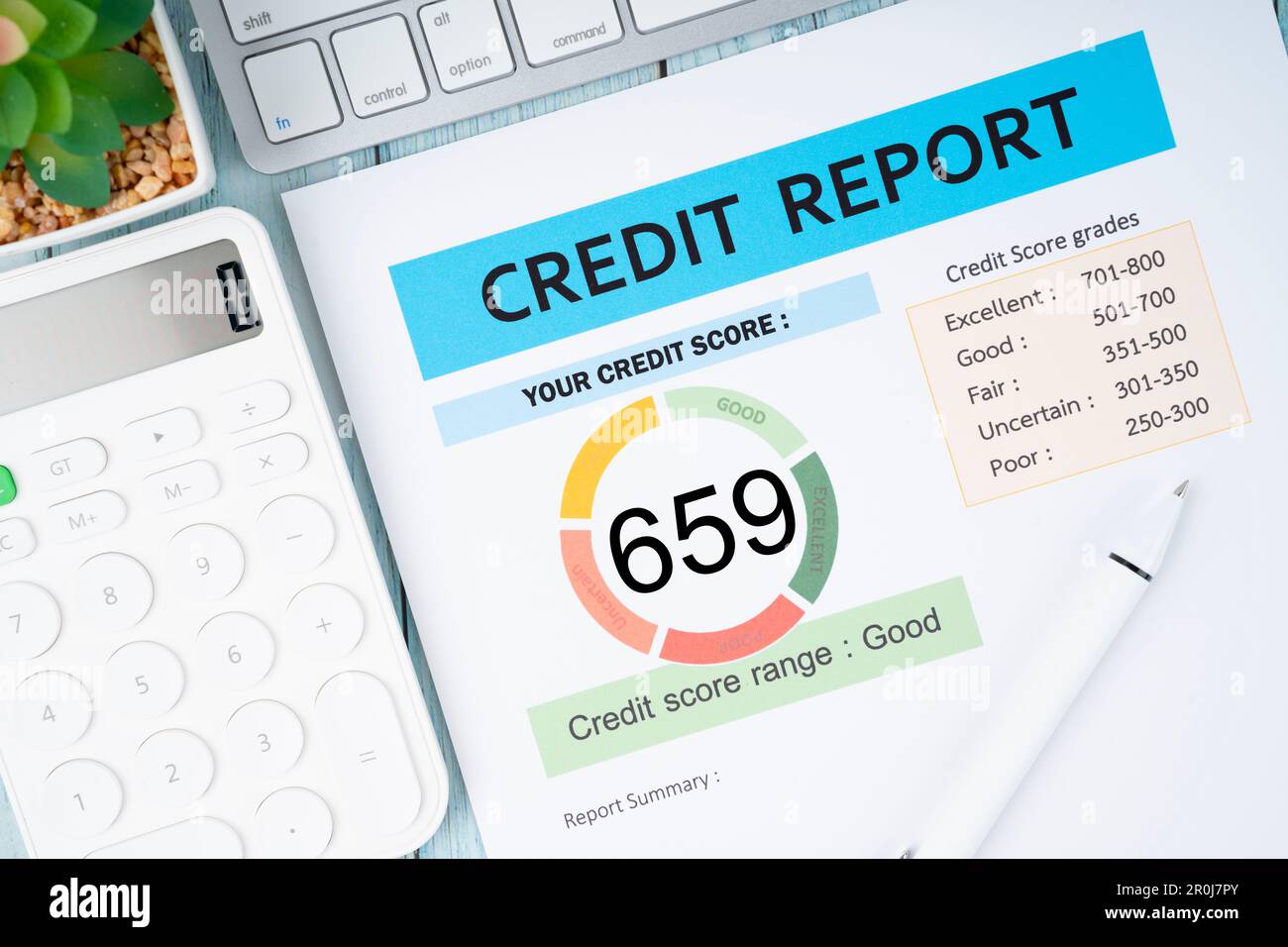 Credit score report document and pen with computer keyboard on the desk ...