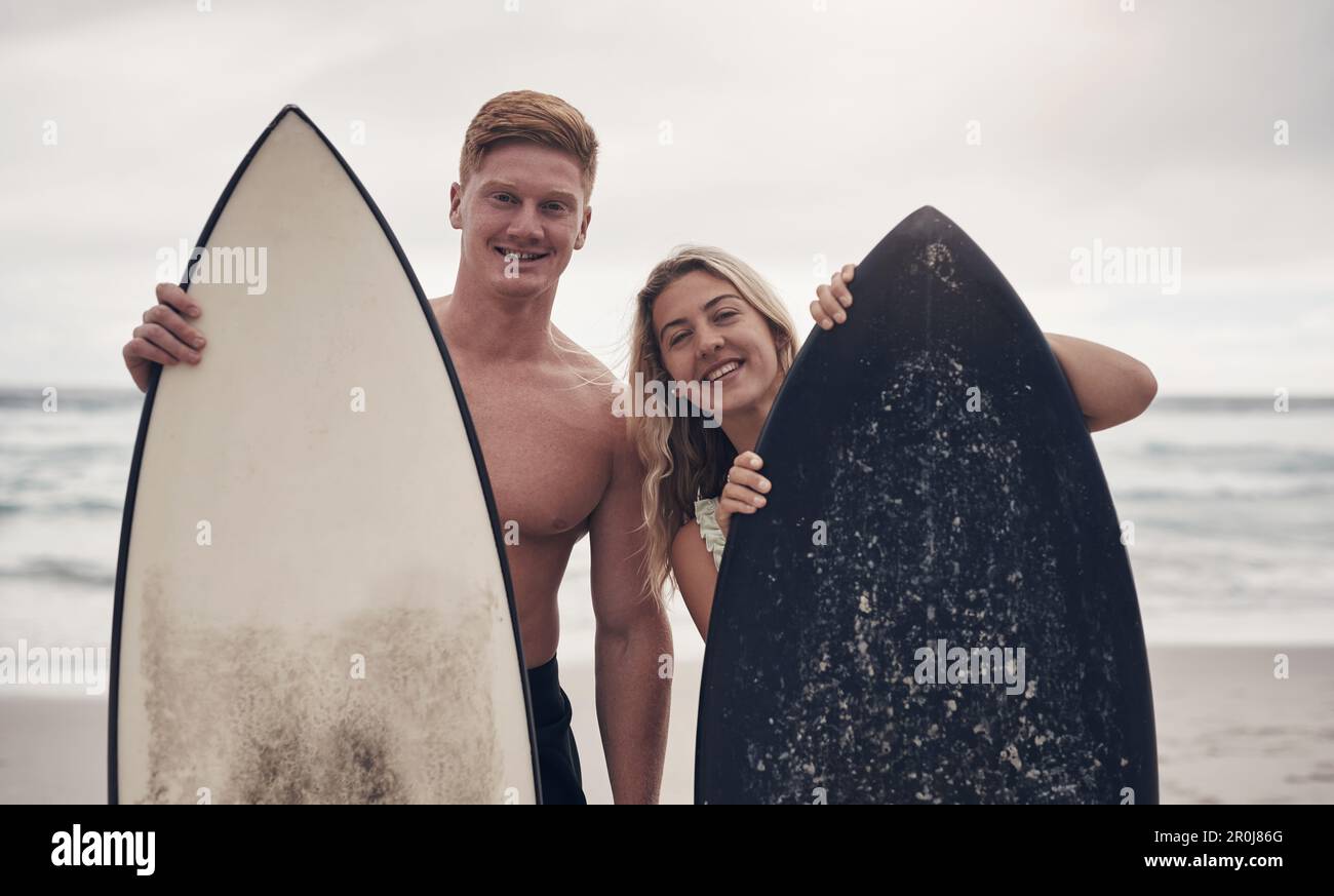 Surfing together made our relationship stronger. a couple out at the beach with their surfboards ...