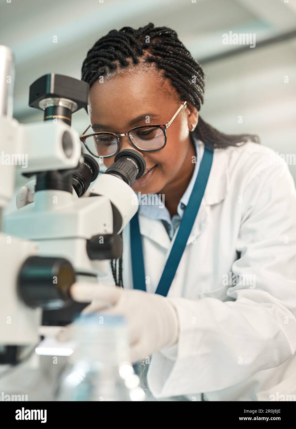 The first step is to observe closely. a young scientist using a microscope in a lab Stock Photo ...