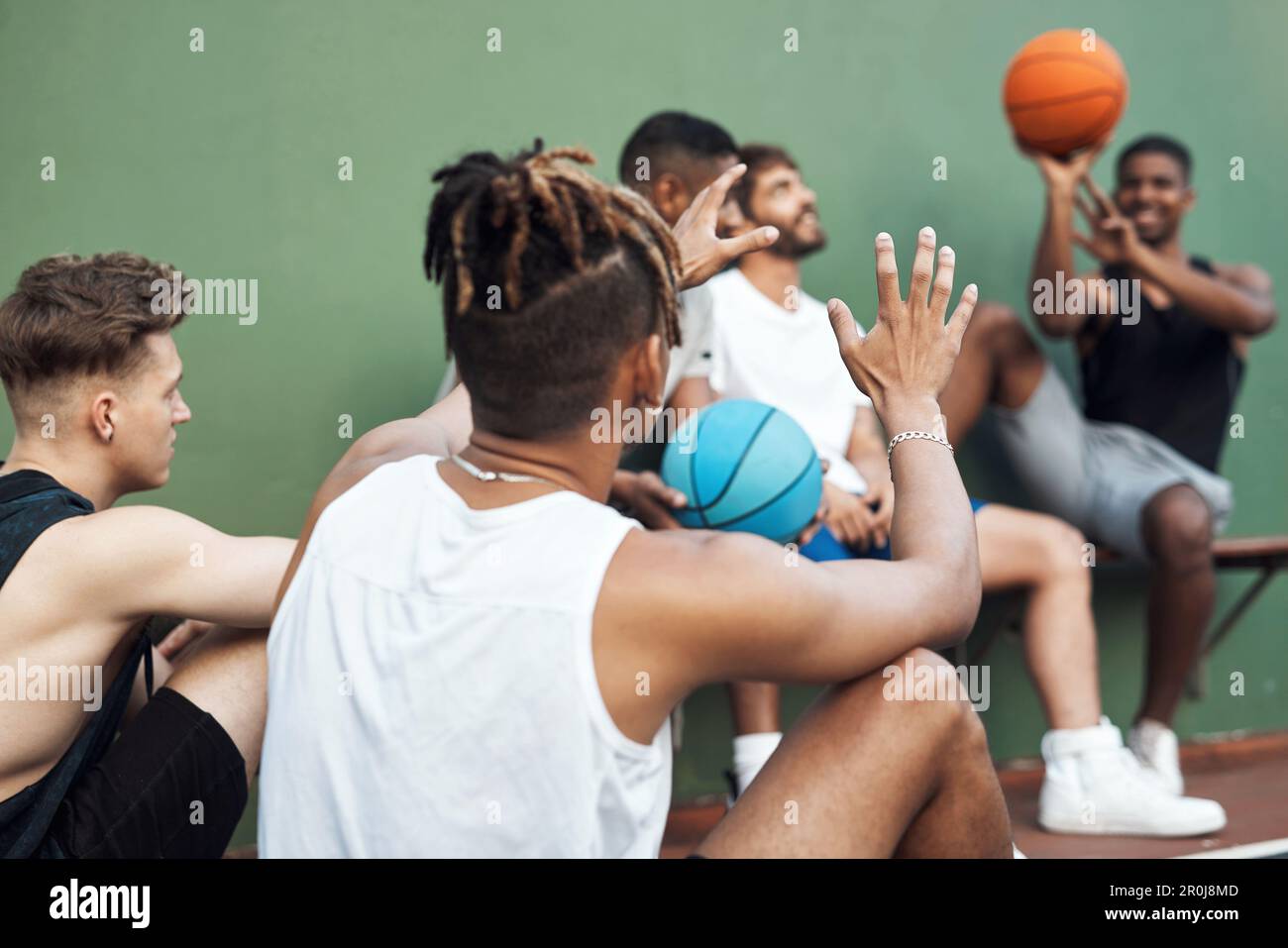 Basketball is a great team building sport. a group of sporty young men ...