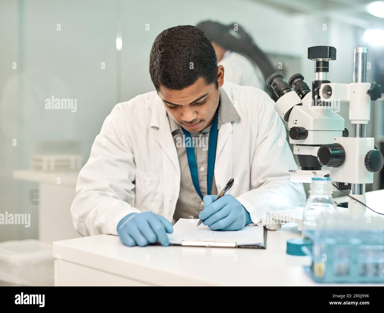 Noting down some important details from his investigation. a young ...