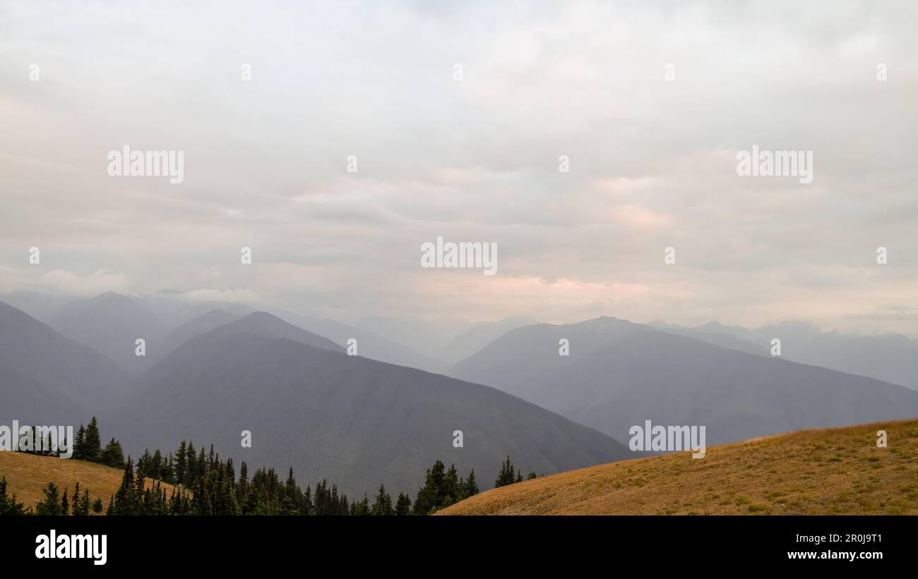 Blue ridge ridge mountain layers with clouds in distance and trees on ...