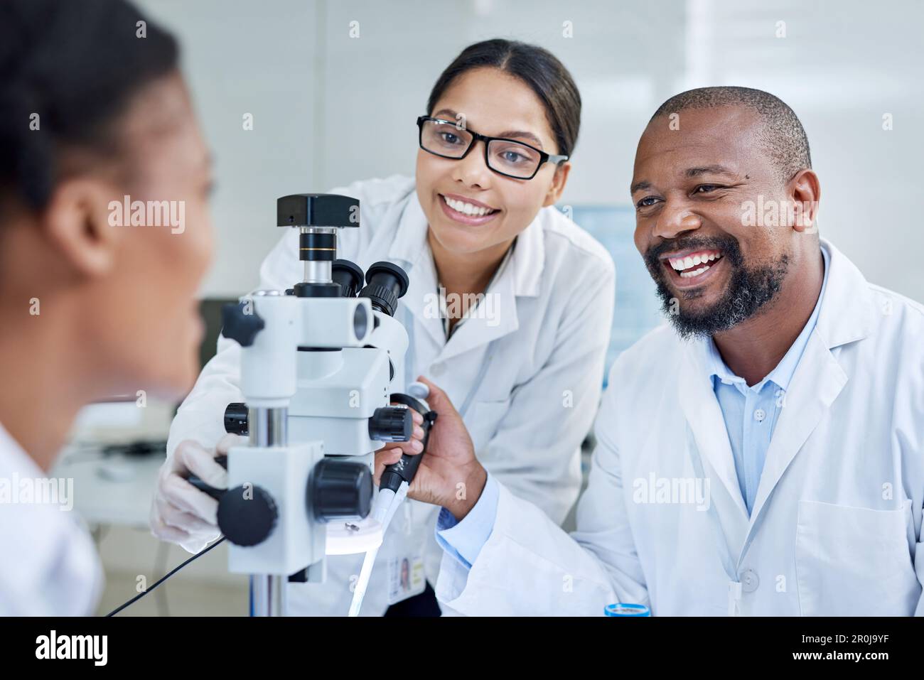 Collaborating to solve the case much quicker. a group of scientists working together in a lab ...