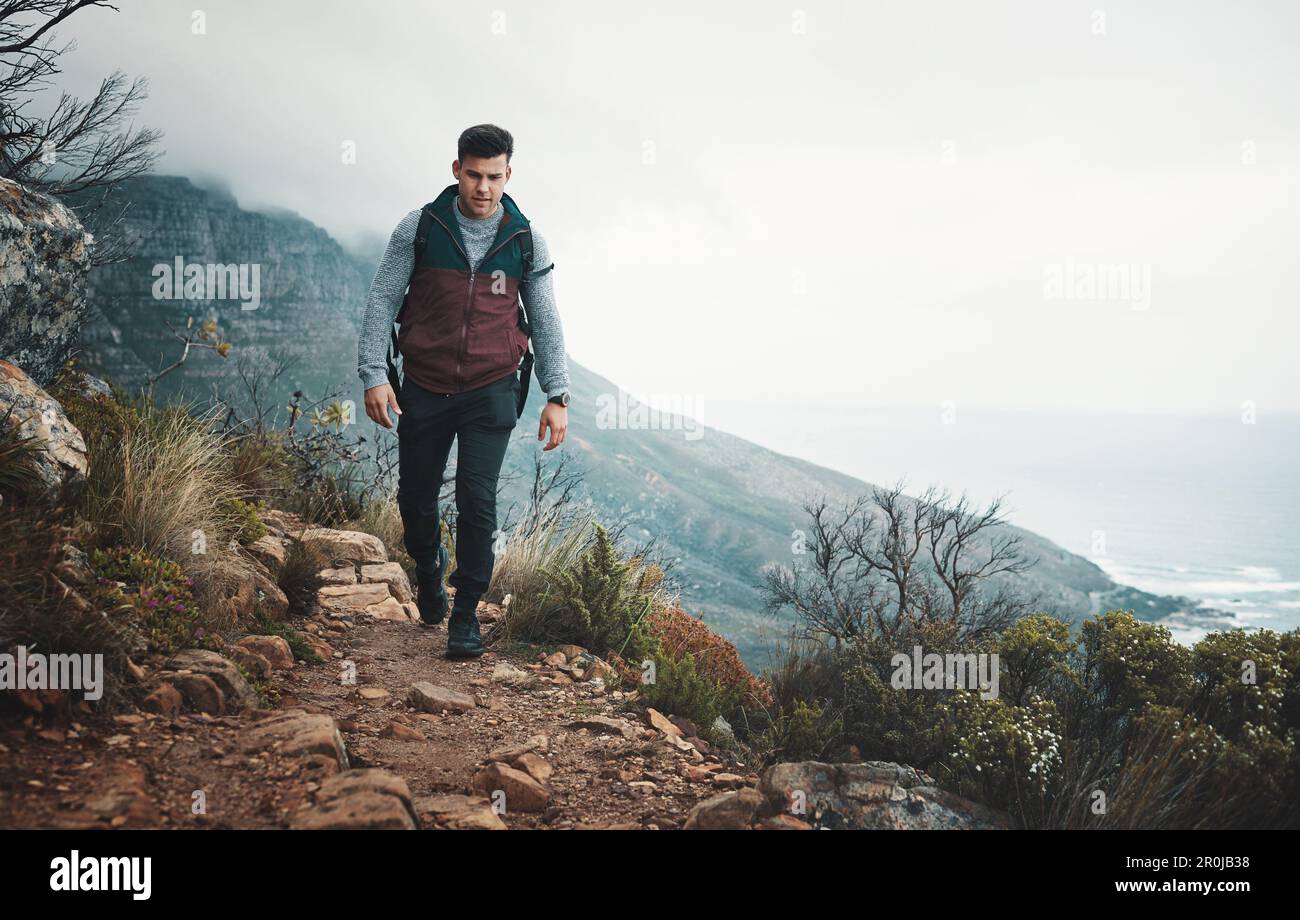 Getting lost is not a waste. a young man hiking through the mountains ...