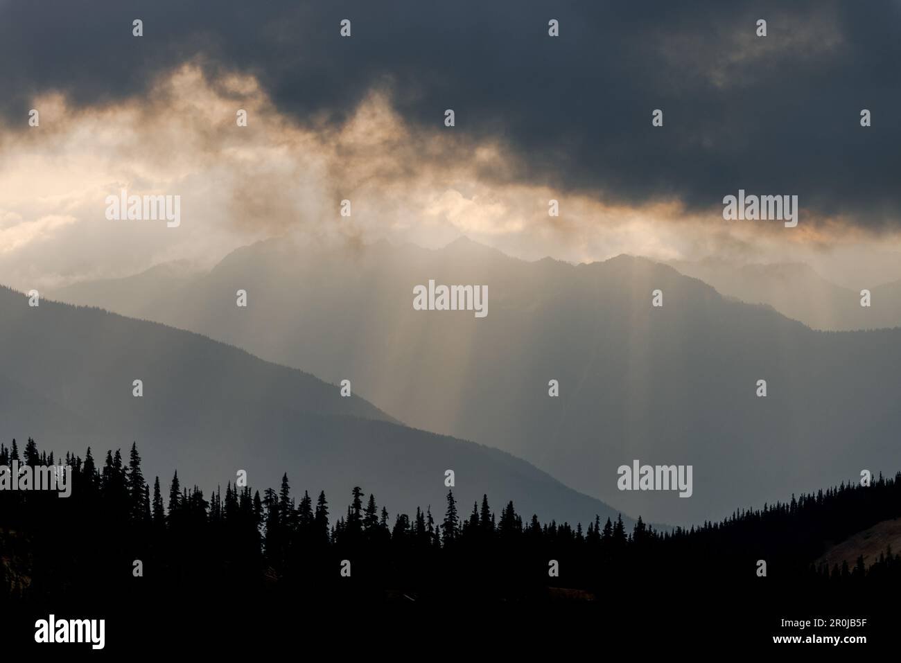 Blue ridge ridge mountain layers with clouds in distance, sun rays ...