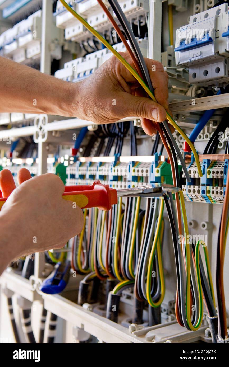 Solar park, electricans switching the wiring of the power system, Hesse ...