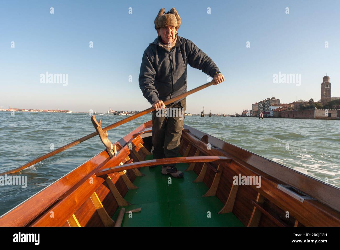 rowing teacher Giorgio, rowing a traditional Sandolo boat in the lagoon ...