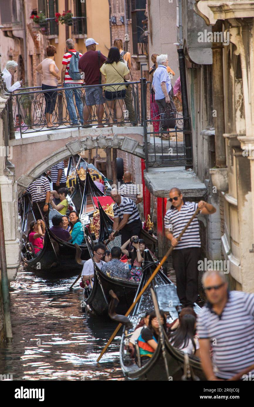 gondola traffic jam, high season, crowds of gondolas in a narrow canal ...