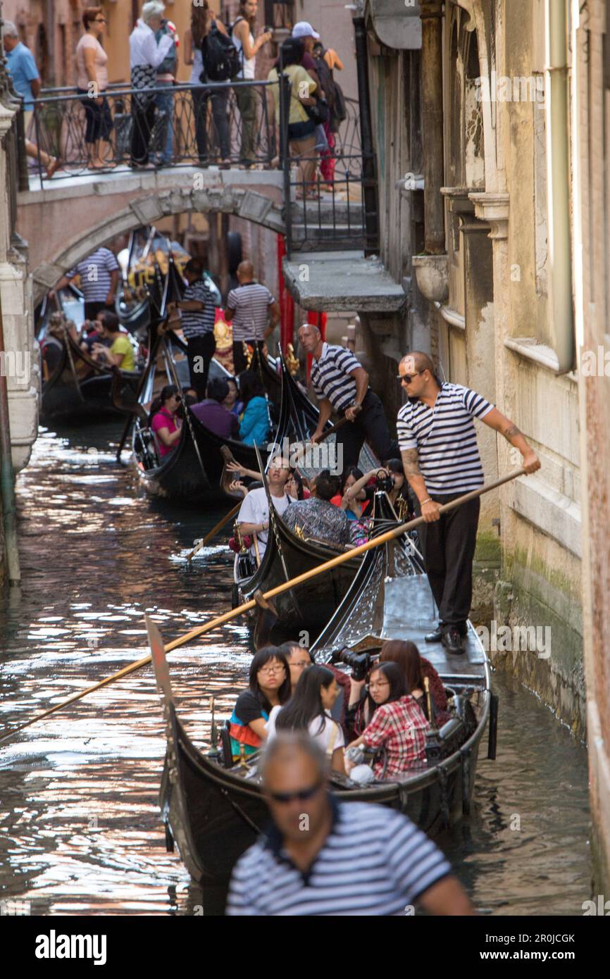 gondola traffic jam, high season, crowds of gondolas in a narrow canal ...