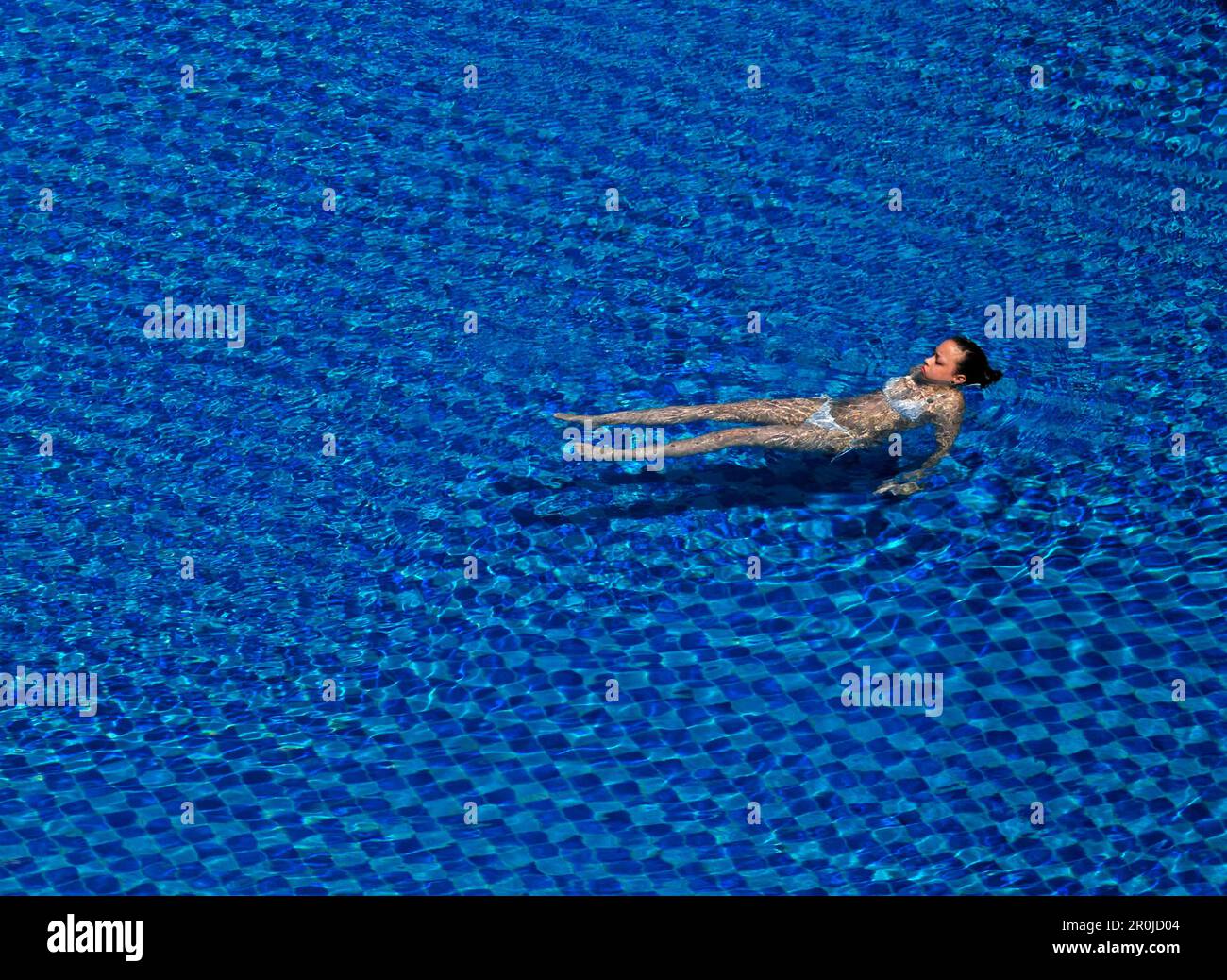 A tourist swimming in the pool of the Ibis hotel in Bangkok, Thailand ...