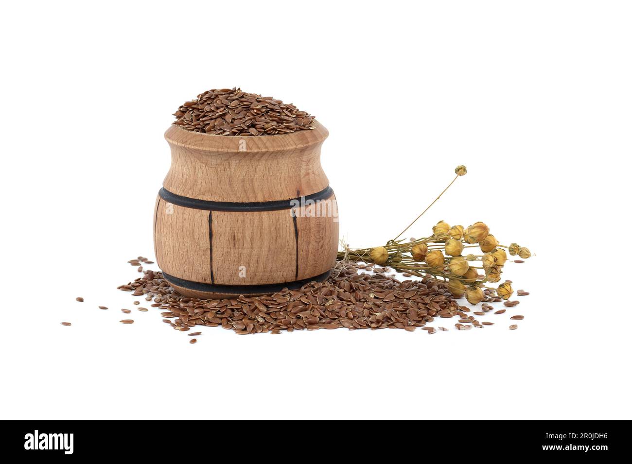 Linseed in small wooden barrel near bunch of flax plants isolated on white background Stock ...